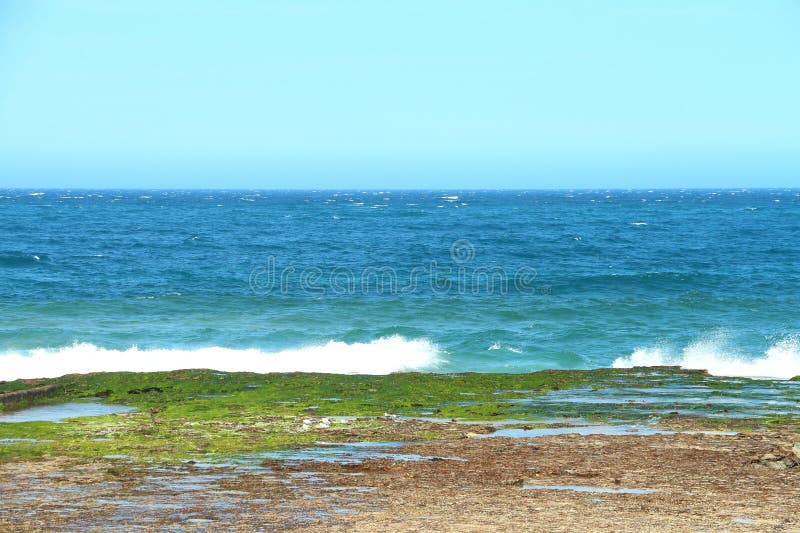 Peaceful Ocean with Waves Crashing Against the Shore and Distant View ...
