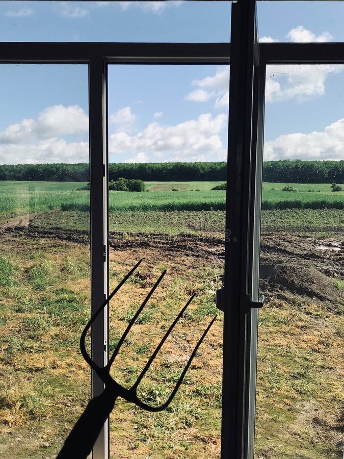Peaceful Rural Landscape through a Window with Pitchfork Shadow Stock ...