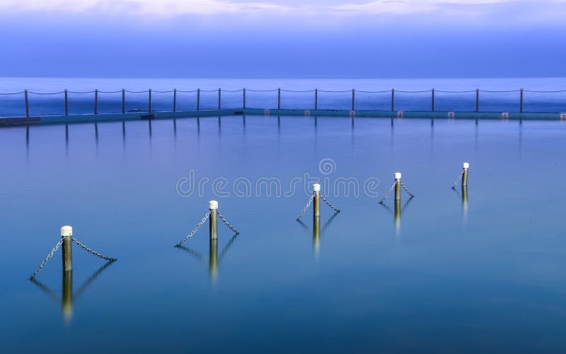A Peaceful Setting with Smooth Water and Reflections of Chains in an ...