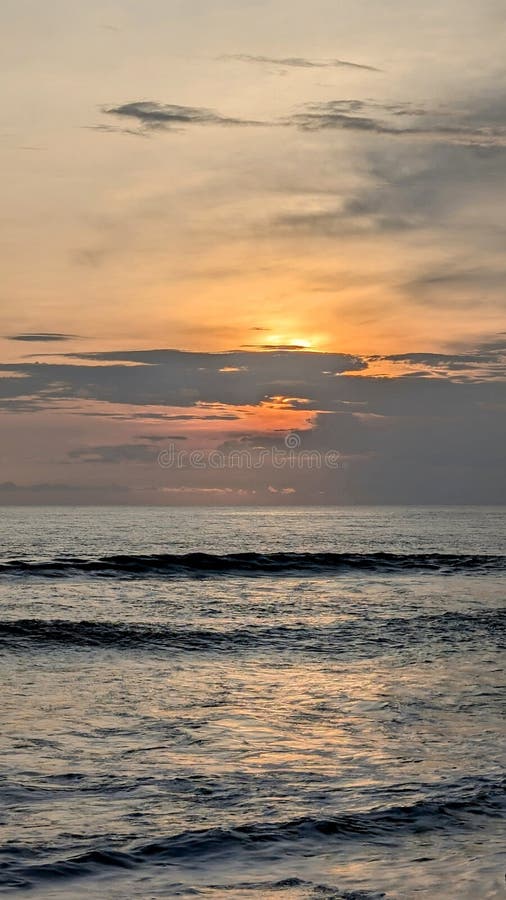 Peaceful Vertical Ocean Sunset with Reflections on Gentle Waves Stock ...