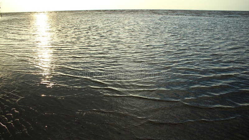 Peaceful Waves Rolling on the Sand at the Seaside with Sun Above the ...
