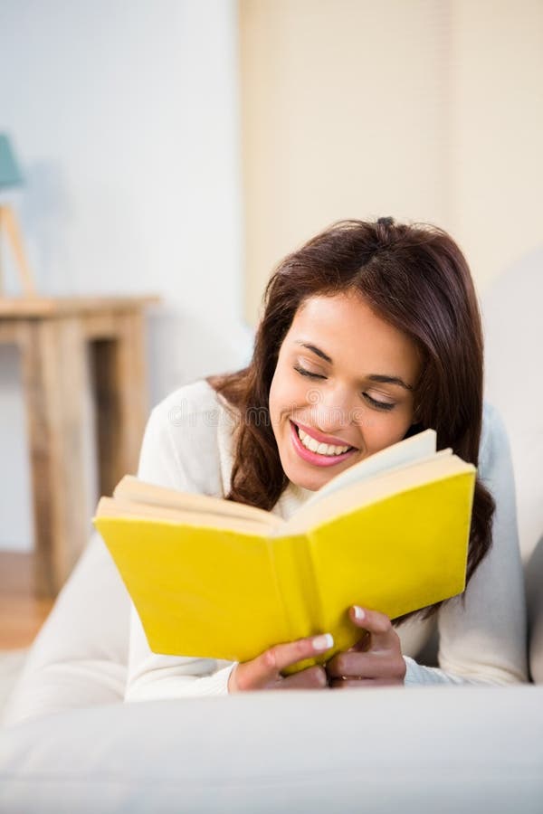 Peaceful Woman Lying on Couch Reading a Book Stock Image - Image of ...