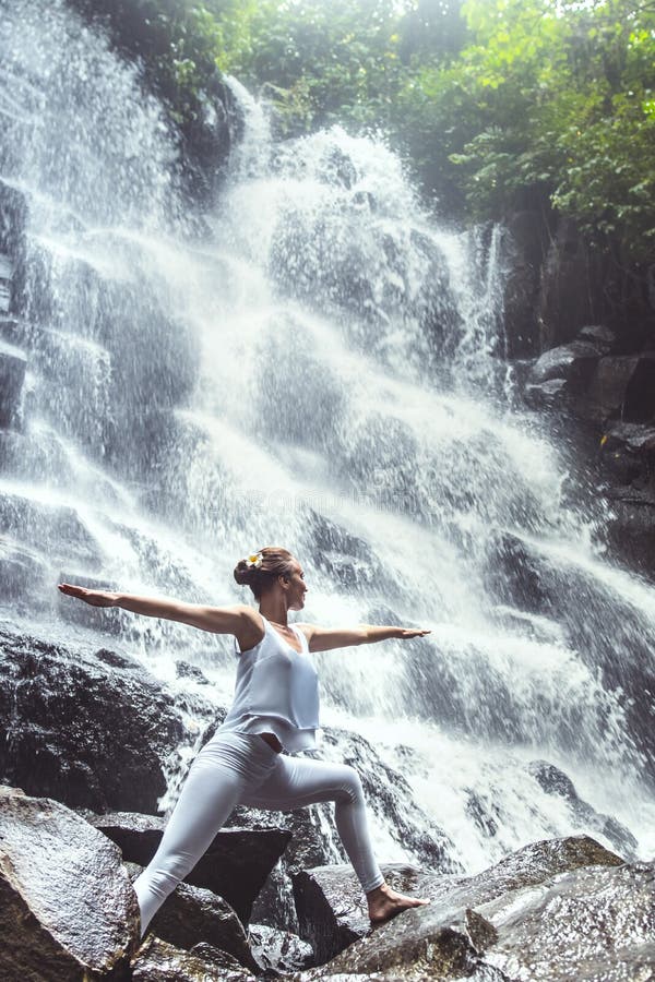 Yoga on the waterfall stock photo. Image of gymnastics - 101944208