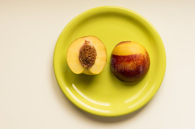 Peach on green plate stock photo. Image of full, color - 52060300