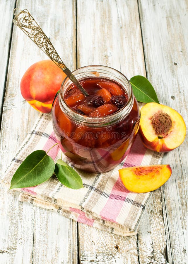 Peach jam in a glass jar stock photo. Image of spoon - 33351366