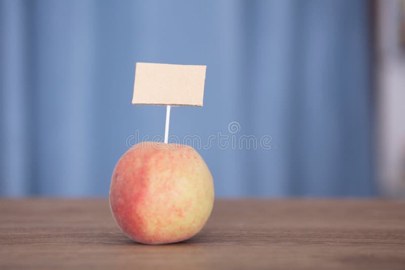 A peach with a price tag stock photo. Image of price - 253702492