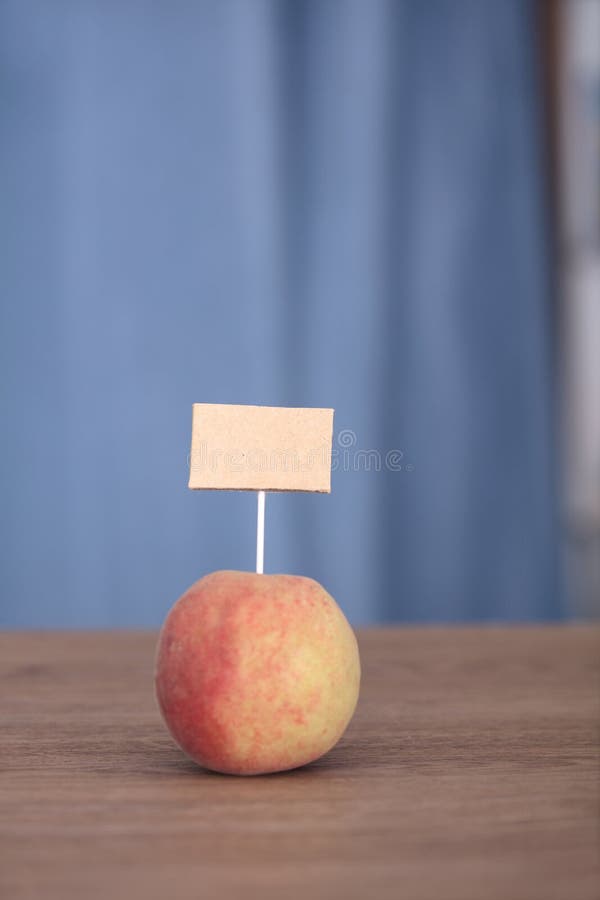 A peach with a price tag stock photo. Image of indoor - 253702508