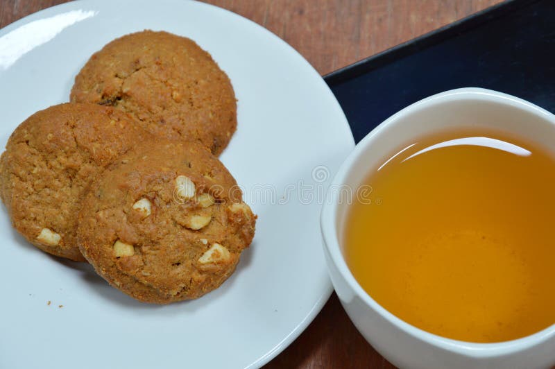 Peanut Cookie and Cup of Tea with Black Cell Phone Stock Image - Image ...