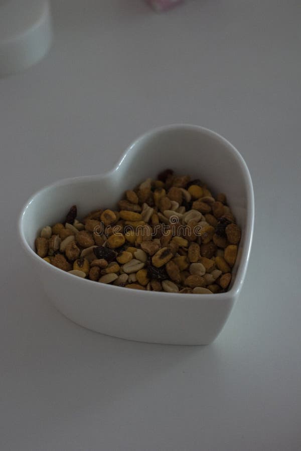 Peanut in Heart-shaped Ceramic Container on a White Table Stock Image ...