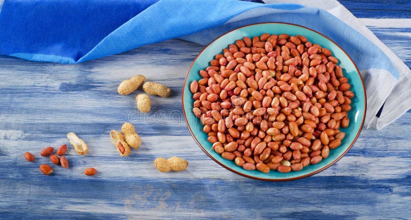 Peanuts on blue plate . stock image. Image of white, table - 56470925
