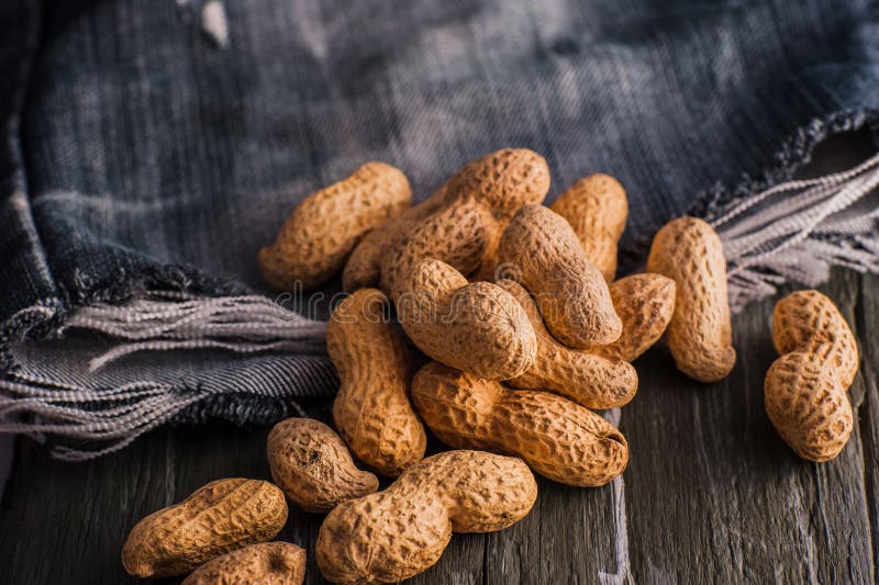 Peanuts in Nutshell on a Piece of Wood Stock Photo - Image of bean ...