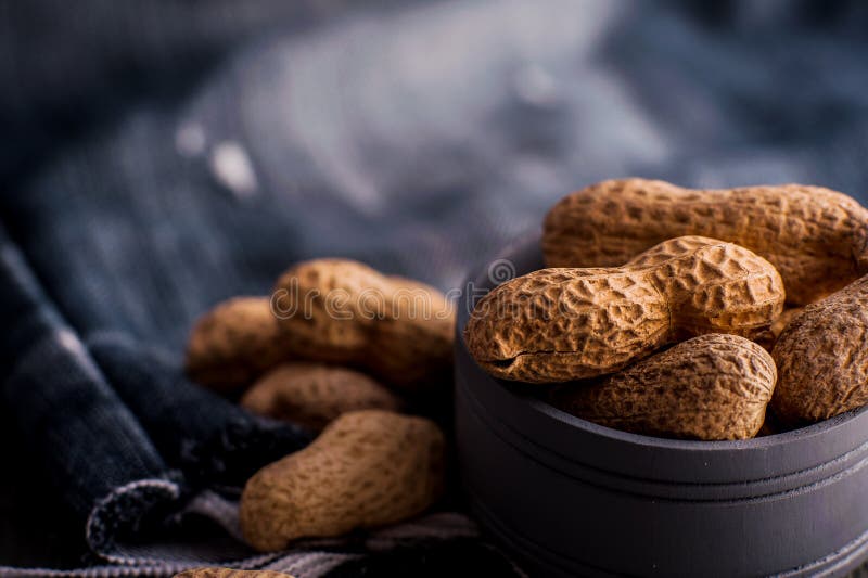 Peanuts in Nutshell on a Piece of Wood Stock Image - Image of selective ...