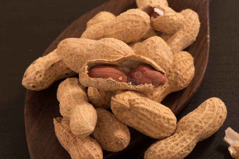 Peanuts with Shell in a Black Color Wooden Spoon. Stock Image - Image ...