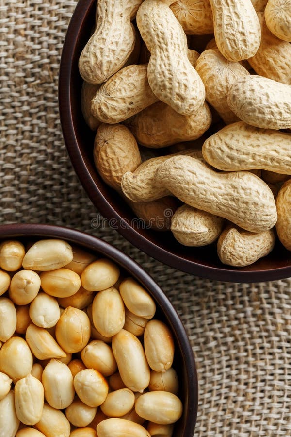 Peanuts in the Shell and Peeled Close-up in Cups. Roasted Peanuts in ...