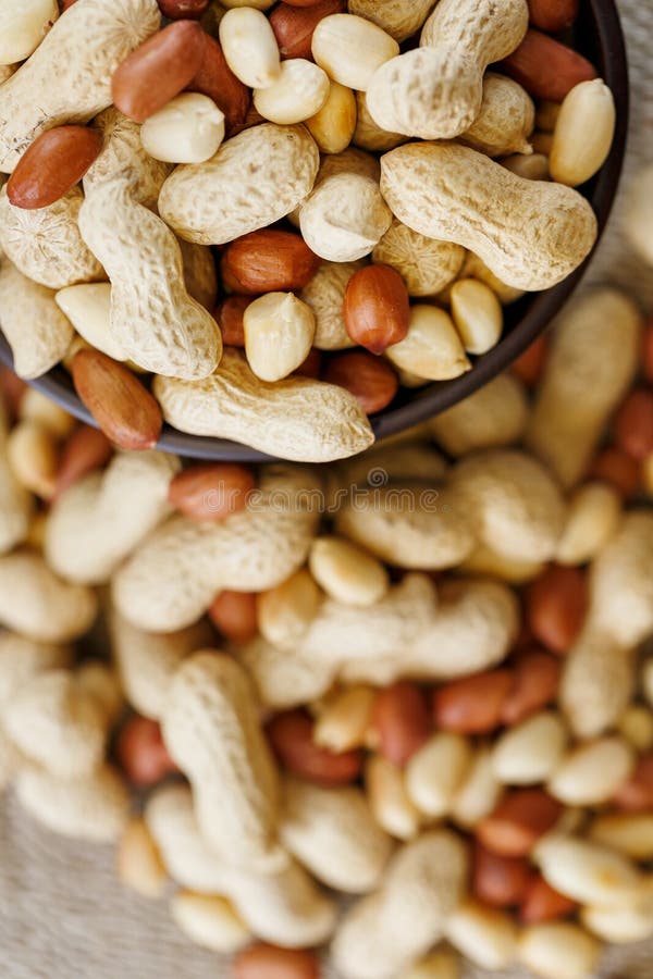 Peanuts in the Shell and Peeled Close-up in Cups. Roasted Peanuts in ...