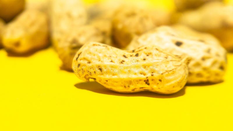 Peanuts that really Stand Out in the Group with a Yellow Background ...