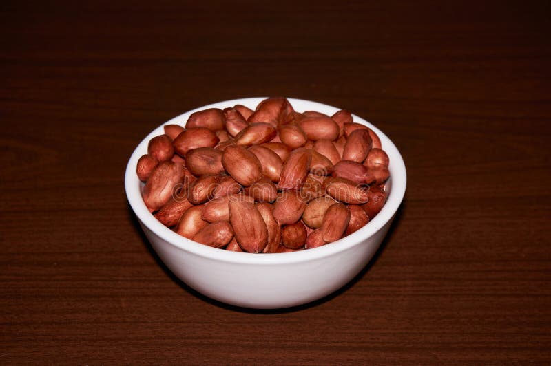 Peanuts in a White Bowl. Against the Background of a Dark Tree. Side ...
