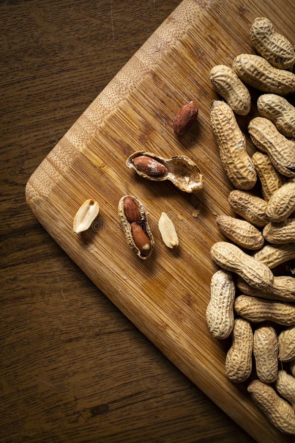 Peanuts on a Wooden Kitchen Board and on a Table Stock Photo - Image of ...