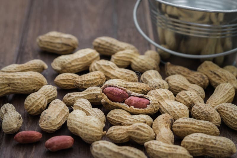 Peanuts on wooden table stock image. Image of protein - 61543063