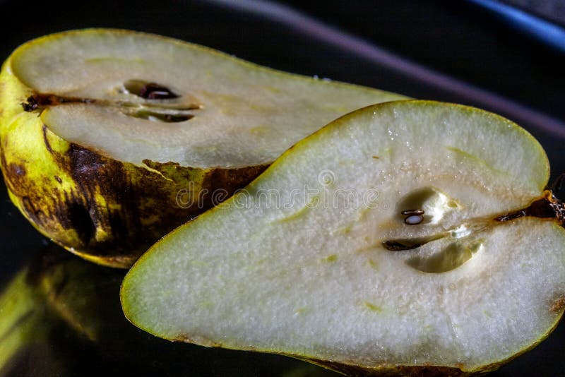 A pear cut inhalf stock photo. Image of yellow, food - 215000130
