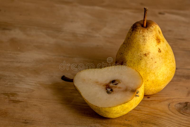 Pear on a Rustic Wooden Table Stock Photo - Image of cutout, yellow ...