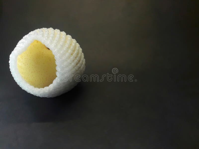 Pear Wrapped in Foam Net with Black Background Stock Image - Image of ...