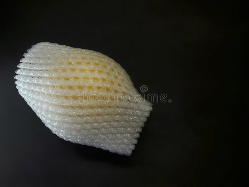 Pear Wrapped in Foam Net with Black Background Stock Photo - Image of ...