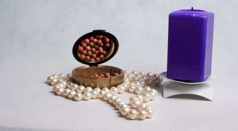 Pearl Beads, a Box of Rouge and Purple Square Candle Stock Photo ...