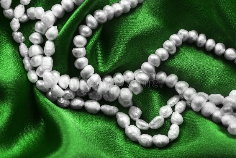 Pearl on green satin stock image. Image of jewelry, white - 83471767