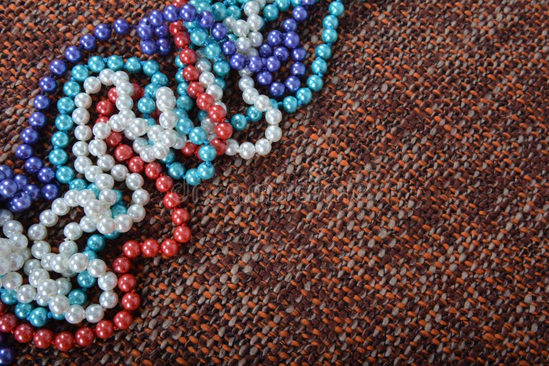 Pearl Necklace on the Brown Fabric Background Texture Stock Photo ...