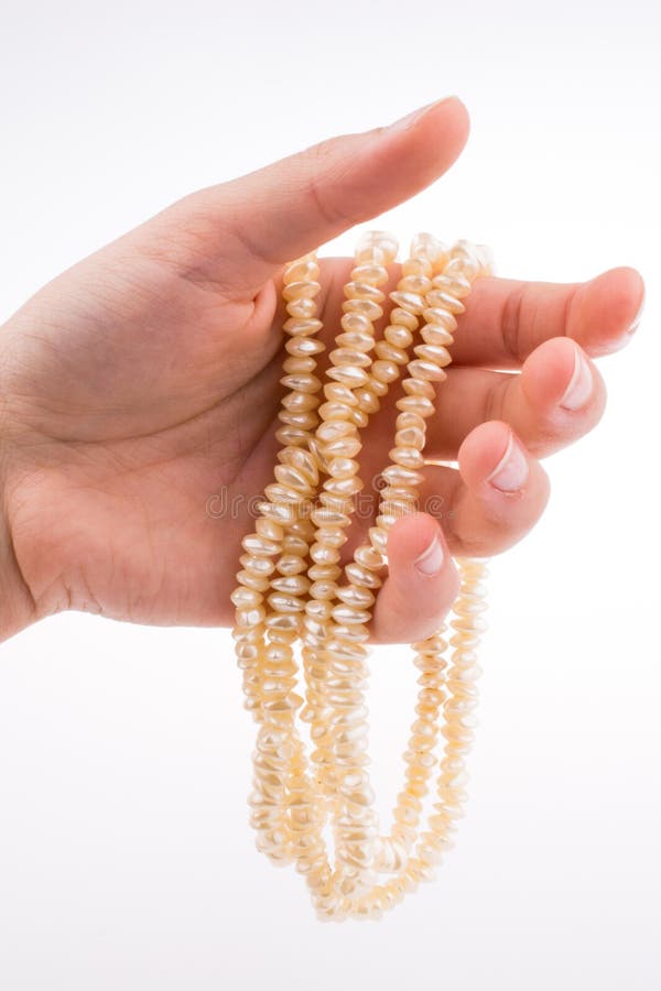 Pearl necklace in hand stock image. Image of white, glamor - 145964315