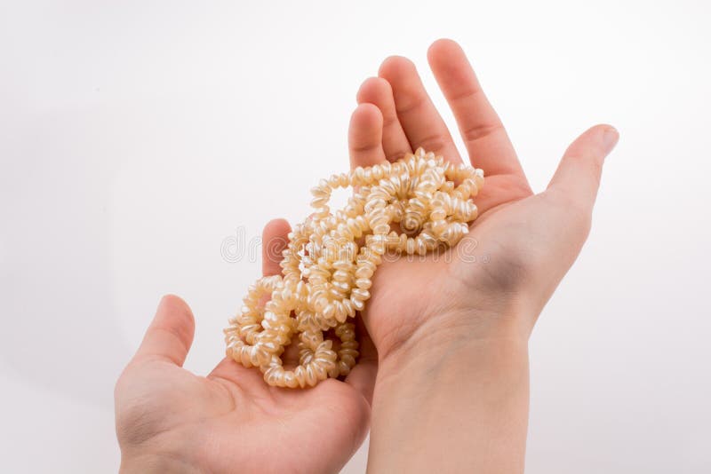 Pearl necklace in hand stock photo. Image of luxury, white - 68612072