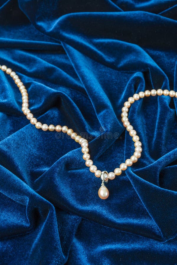 Pearls on blue velvet stock image. Image of shiny, beads - 96182001