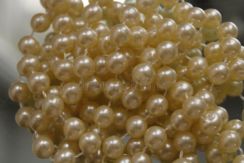 Pearls of Light Color Lie on the Mirror and the Reflection of these ...