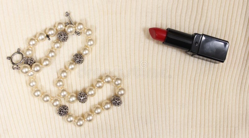 Pearls and Red Lipstick on Cream Colored Sweater Closeup Stock Photo ...