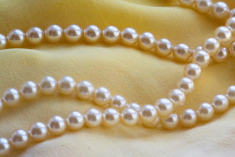 Pearls Threads on a Yellow Fabric. Stock Photo - Image of beige, beads ...