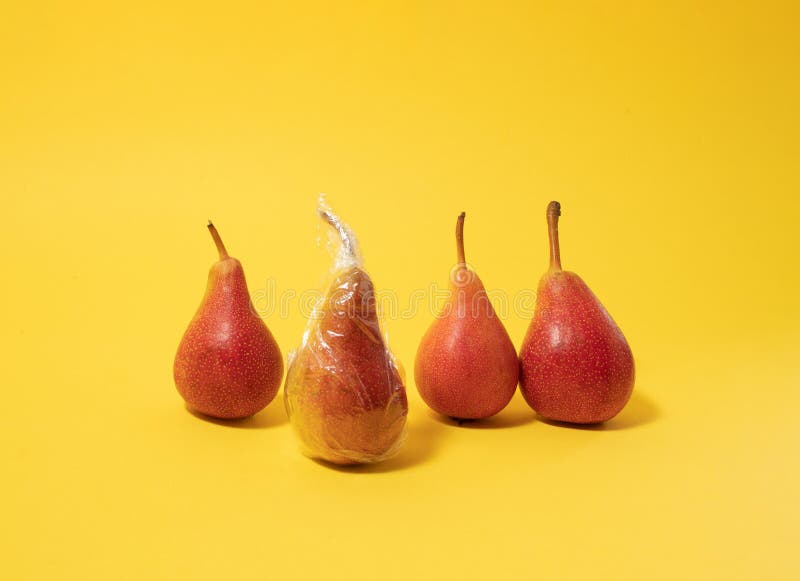 Pears Arranged in a Horizontal Line, One Pear in Plastic Foil. Top View ...