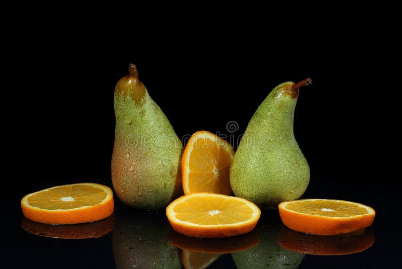 Pears with orange slices stock image. Image of isolated - 209802631