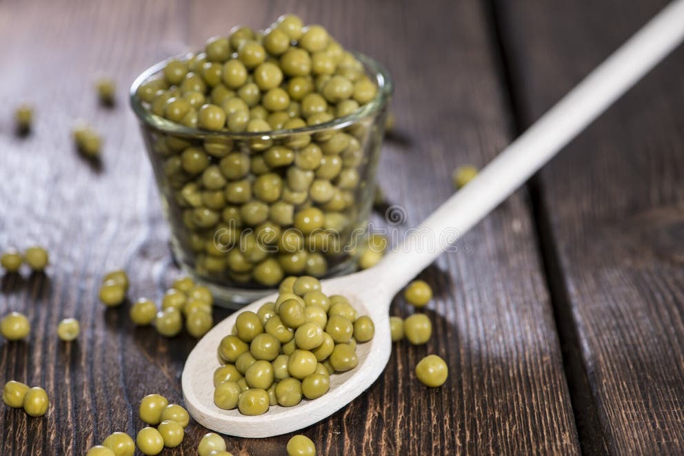 Peas on a wooden spoon stock photo. Image of objects - 31890146