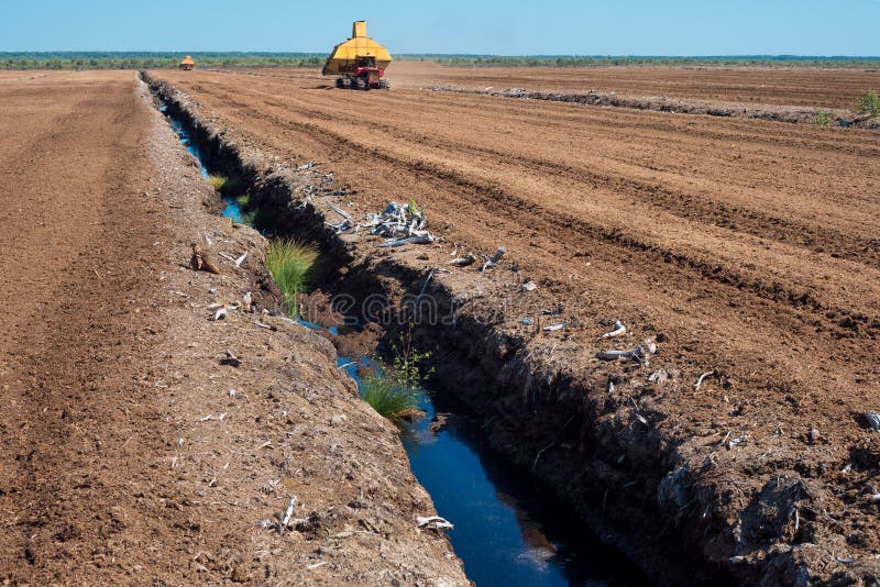 Peat extraction process stock photo. Image of brown - 127964396