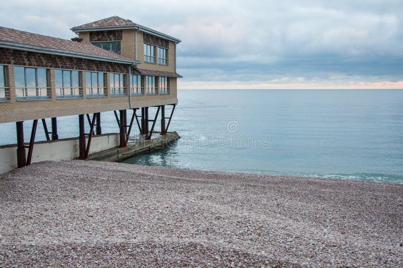 Pebble Beach with a House on the Pier at Sunset Stock Image - Image of ...
