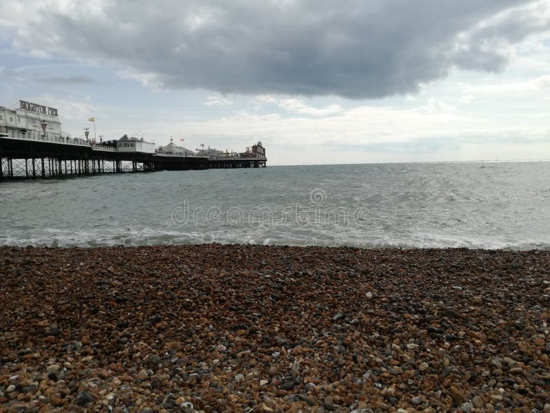 Pebble beach editorial stock image. Image of ocean, pier - 107021584