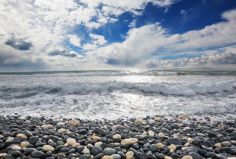 Pebble beach stock image. Image of tranquil, ocean, shiny - 230556995