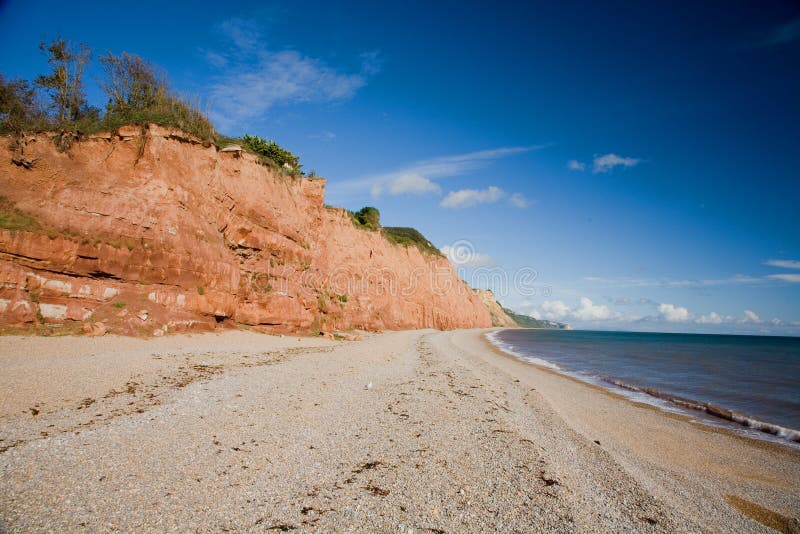 Pebble Beach and Sandstone Cliffs Stock Photo - Image of waves ...