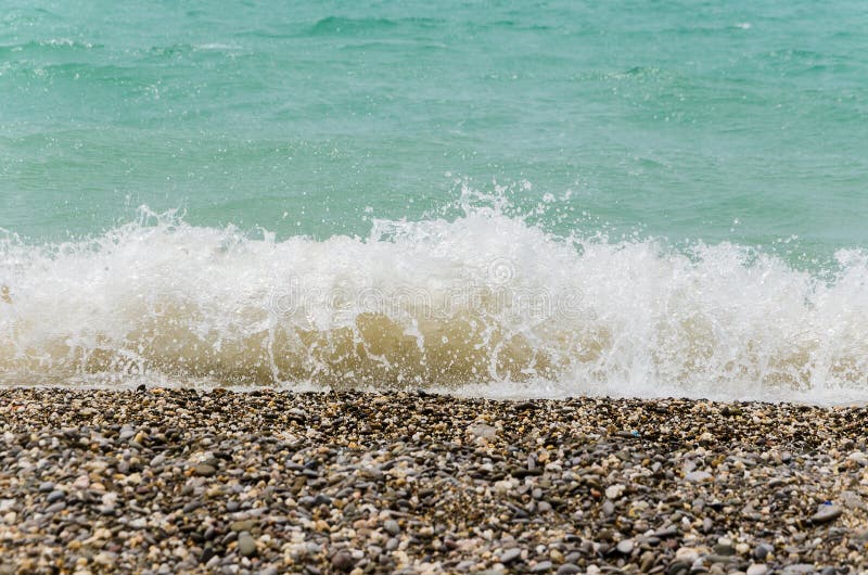 Pebble beach and sea waves stock image. Image of idyllic - 149523601
