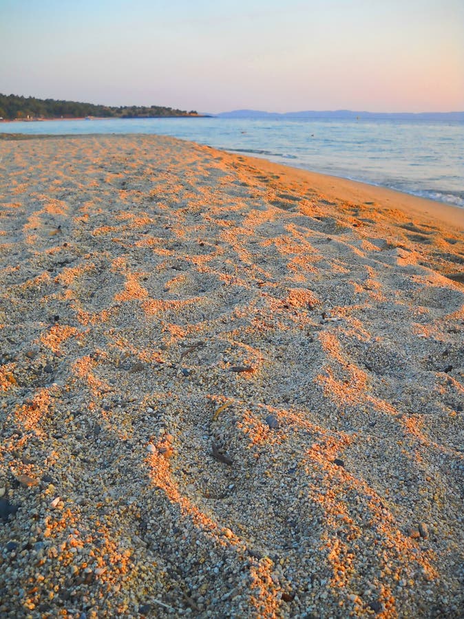 Pebble beach at sunset stock photo. Image of peaceful - 93982794