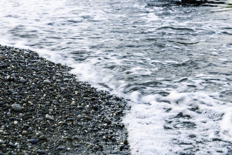 Pebble Beach Washed by Sea Water with Foam Stock Photo - Image of water ...