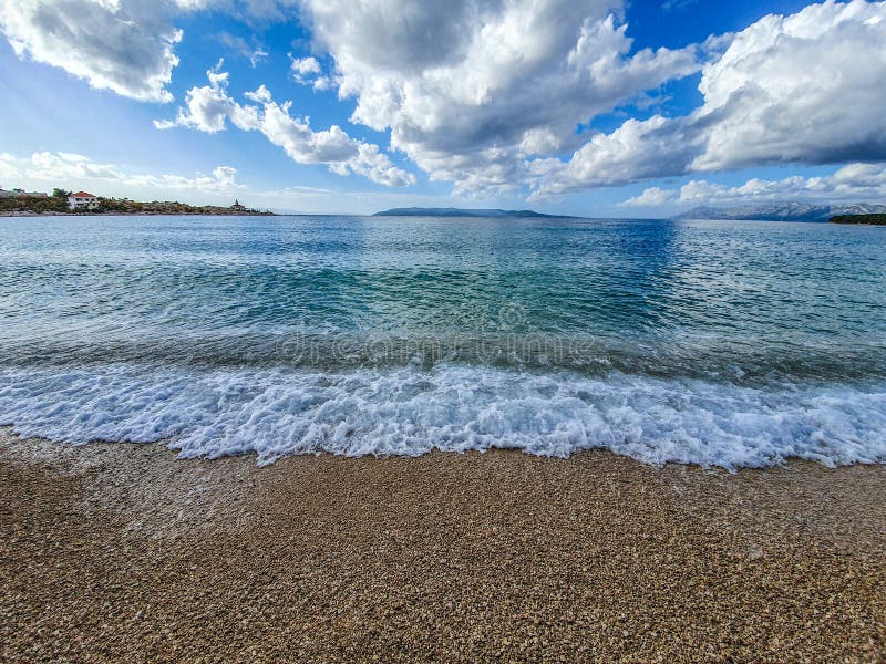Pebble beach and wave foam stock image. Image of salt - 163378751