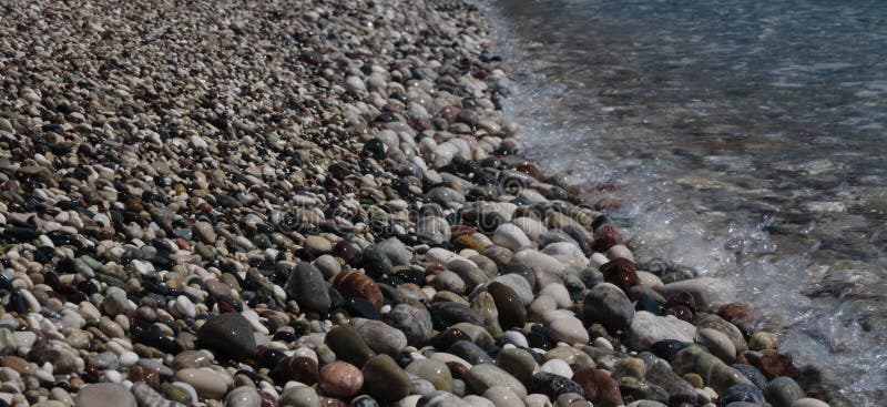 Pebble beach stock image. Image of colourful, water, holiday - 55366081