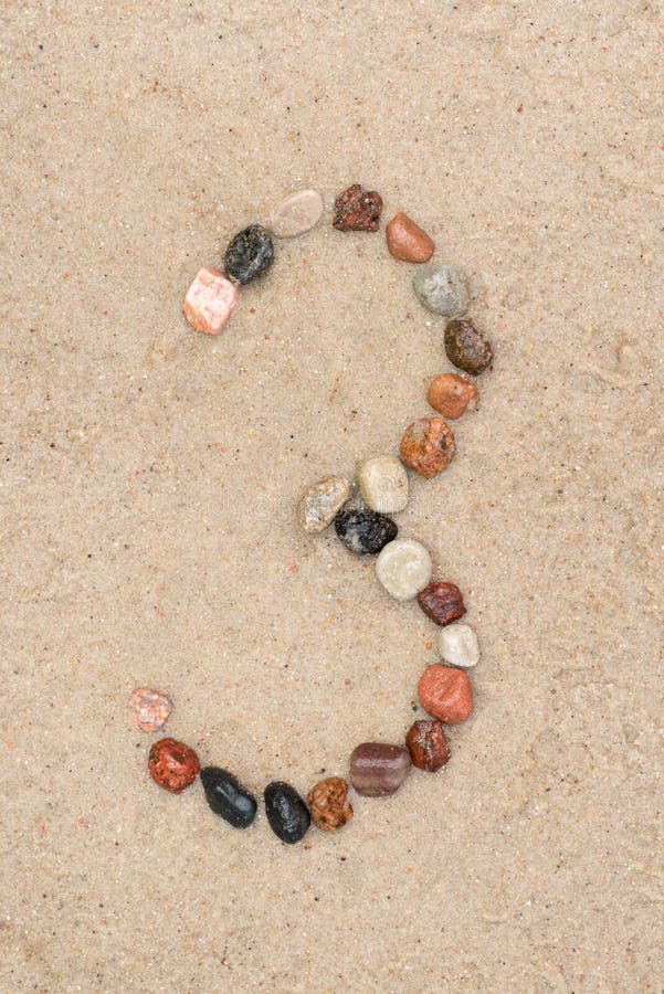 Pebble 3 Number on Sand Selective Focus Stock Photo - Image of color ...